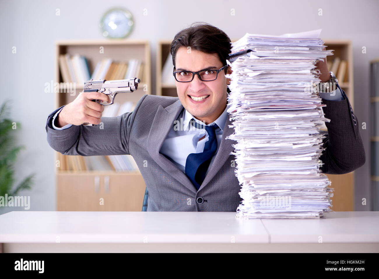 Businessman struggling to meet challenging deadlines Stock Photo - Alamy