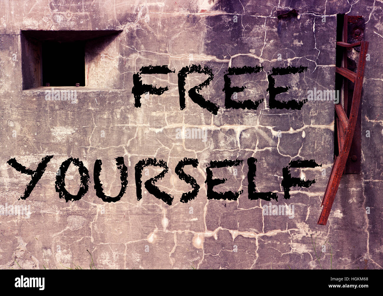 gray cement wall with the word Free Yourself Stock Photo - Alamy
