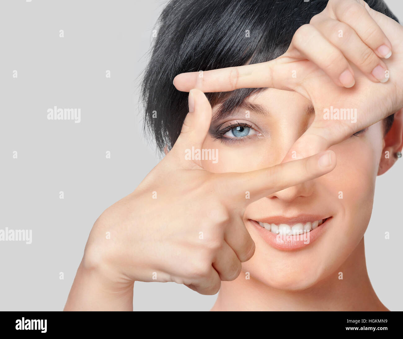 Woman making frame with fingers Stock Photo - Alamy