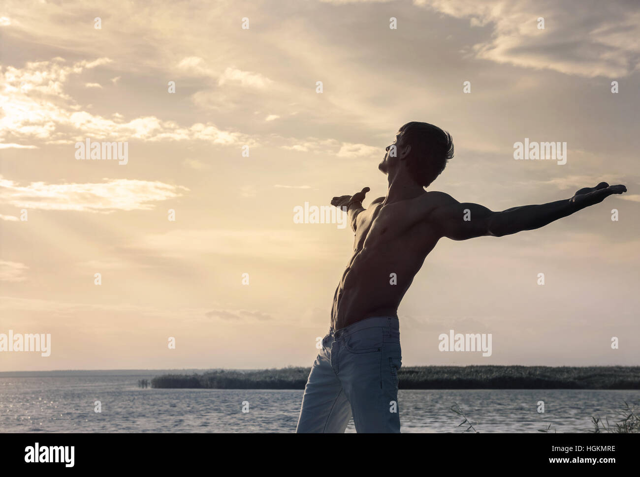 Silhouette of man with outstretched arms on sky background Stock Photo ...
