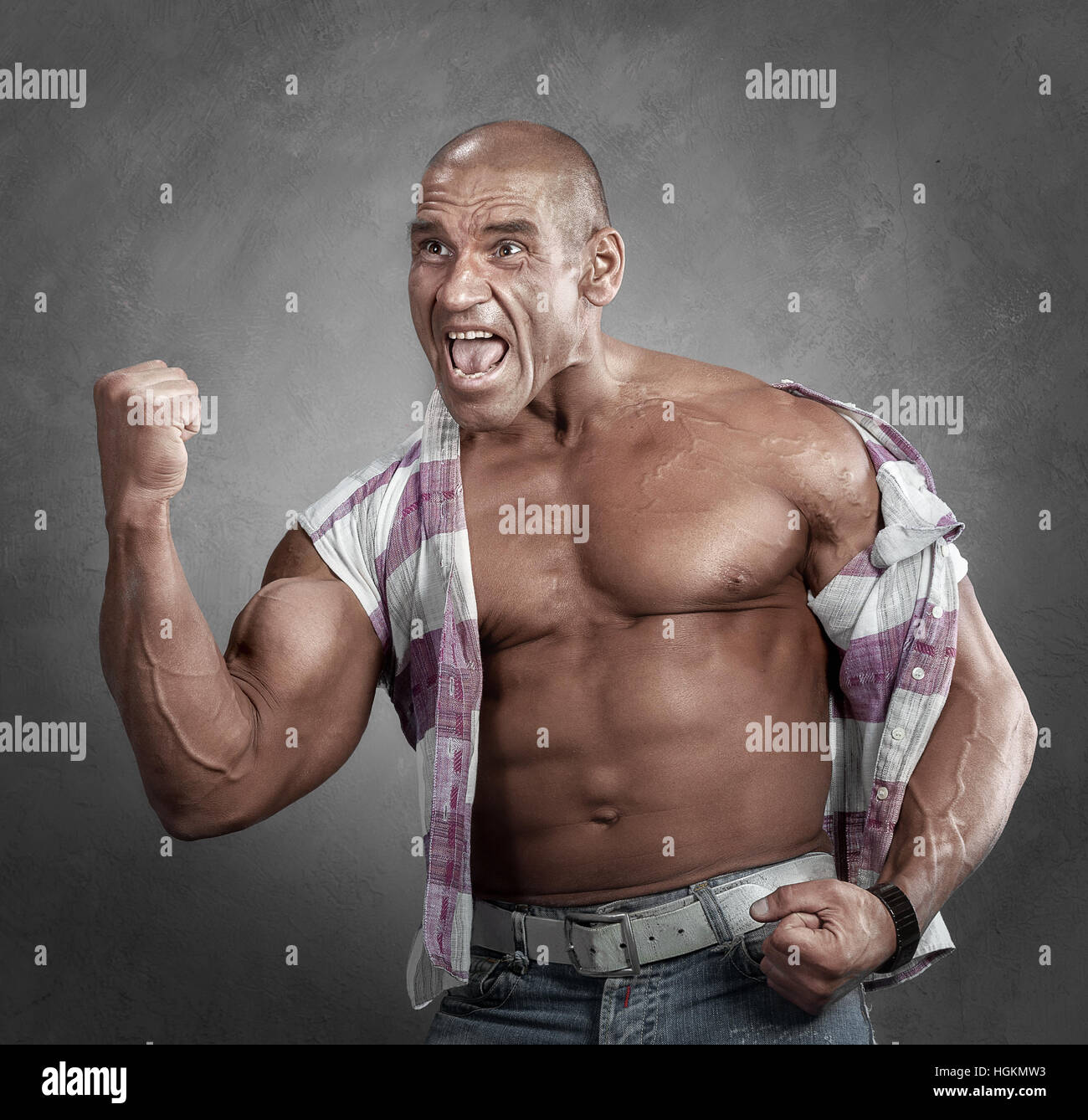 Expressive angry muscular man showing gesture his fist Stock Photo - Alamy
