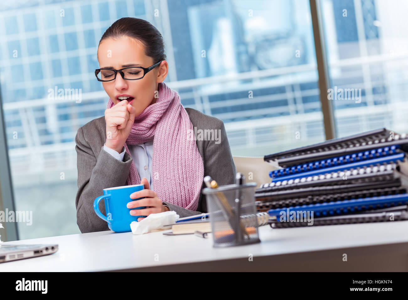 Young businesswoman sick in the office Stock Photo - Alamy