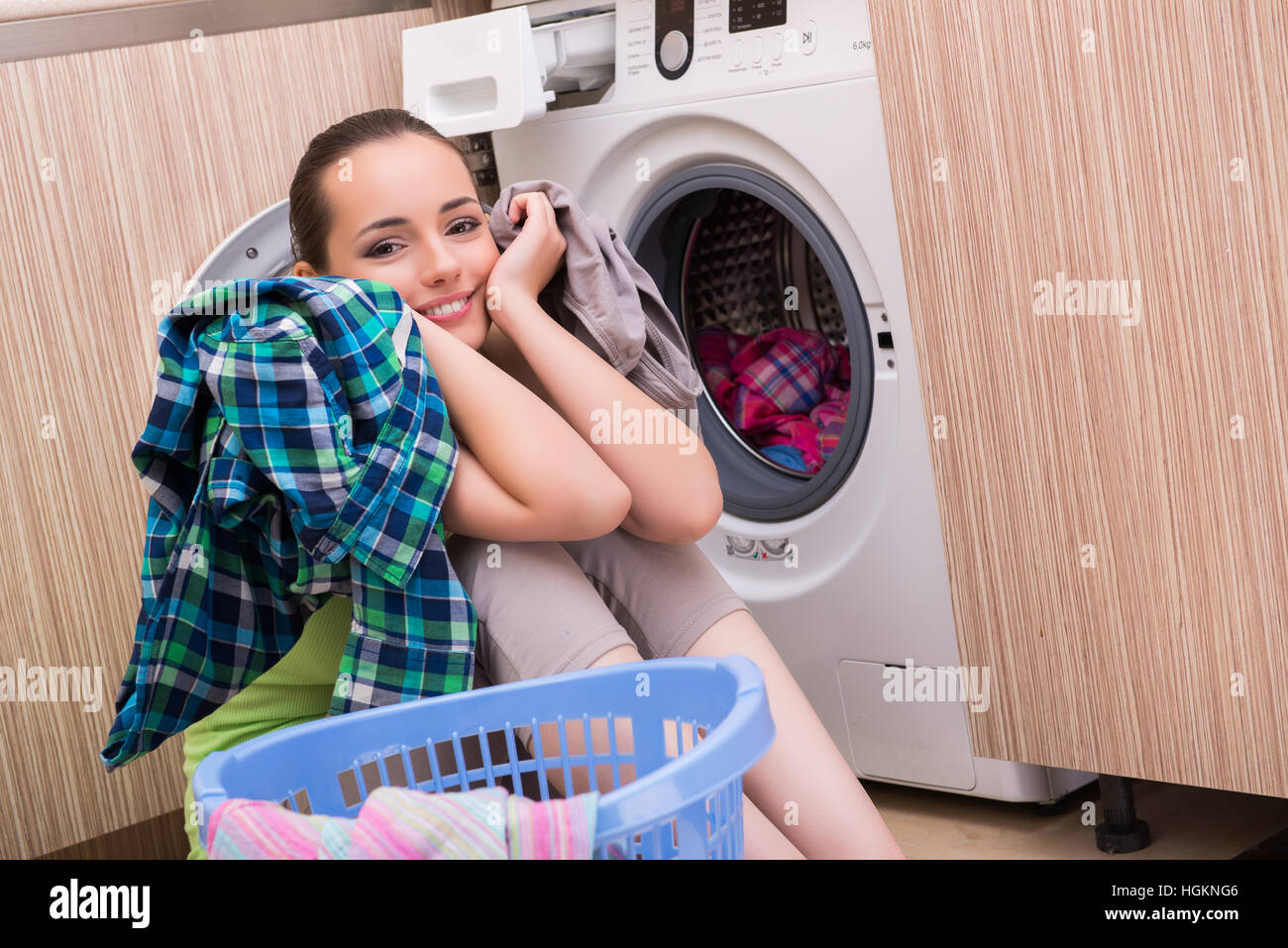 Young wife woman washing clothes near machine Stock Photo - Alamy