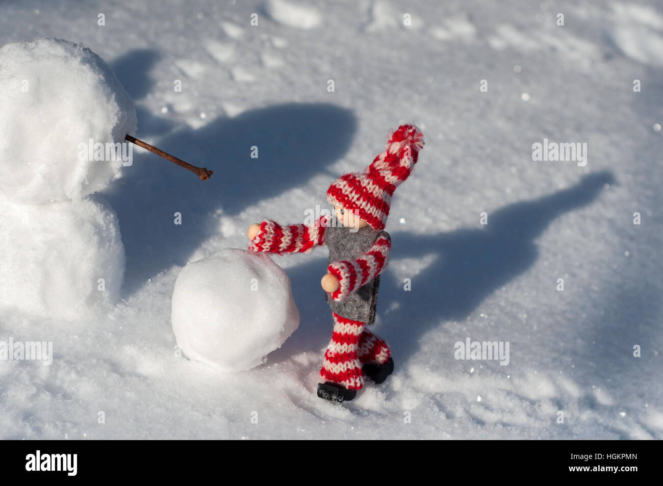 Little toy manikin builds a snowman bright winter day Stock Photo - Alamy
