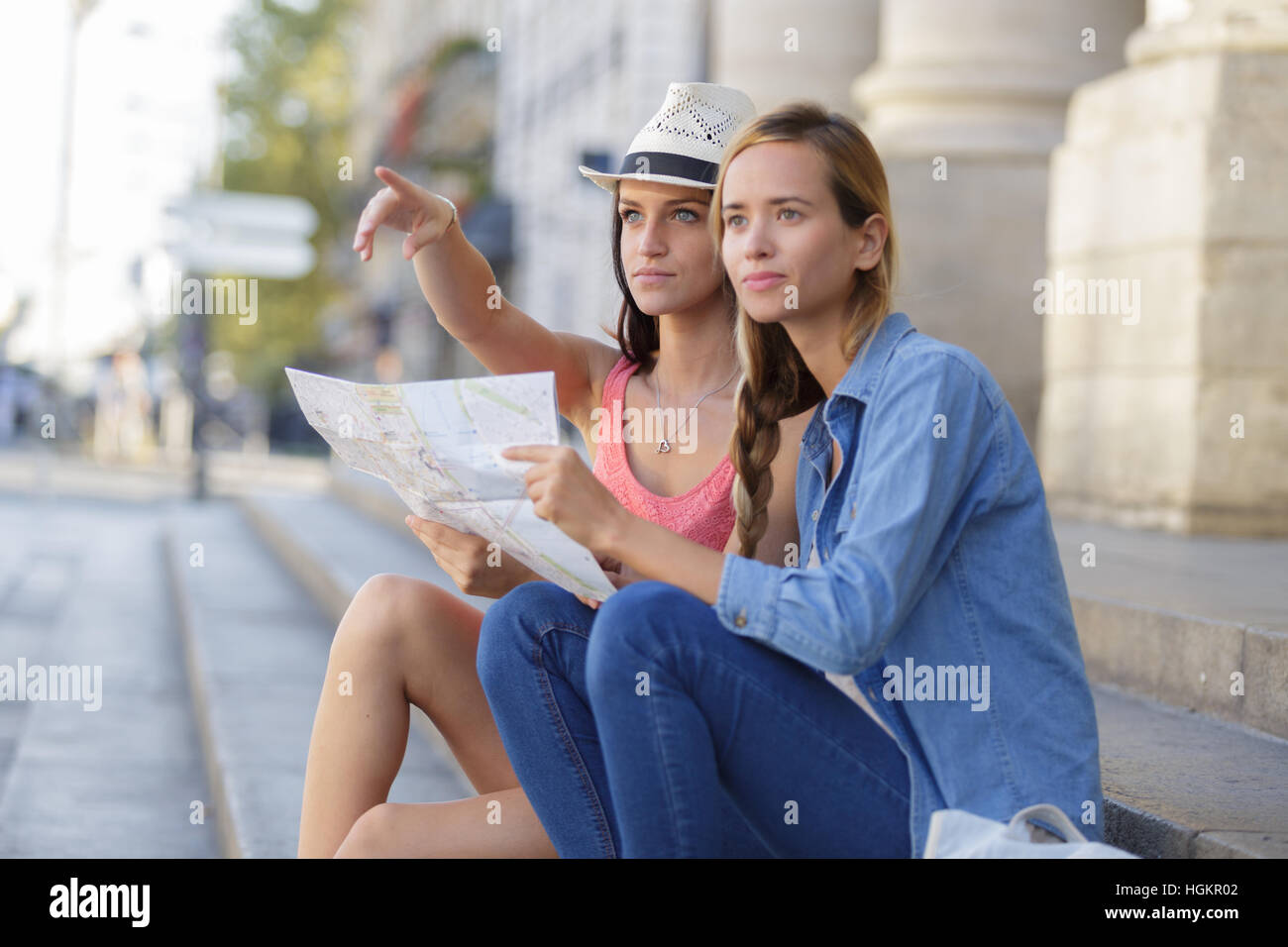 lost and confused girl friends looking for directions on map Stock ...