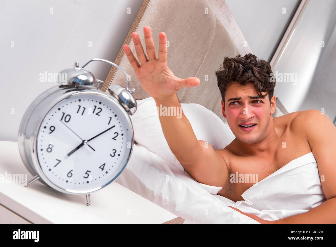 Man having trouble waking up in the morning Stock Photo - Alamy
