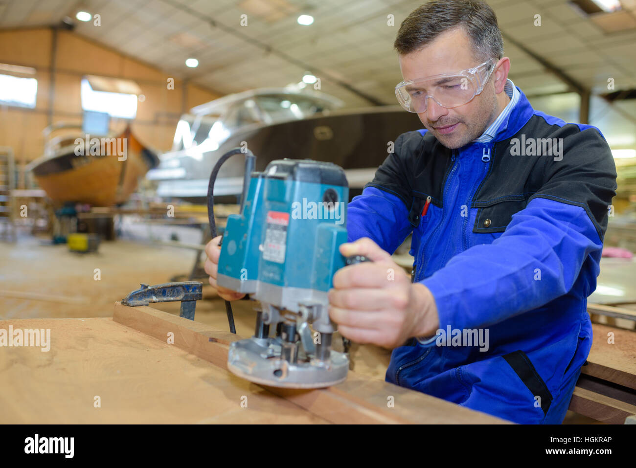 Male worker using router Stock Photo - Alamy