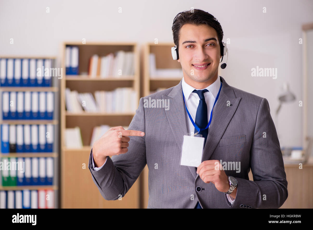 Handsome customer service clerk with headset Stock Photo - Alamy
