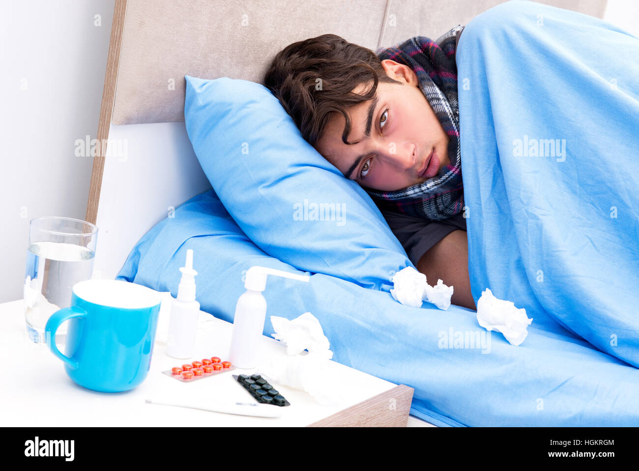 Sick man with flu lying in the bed Stock Photo - Alamy