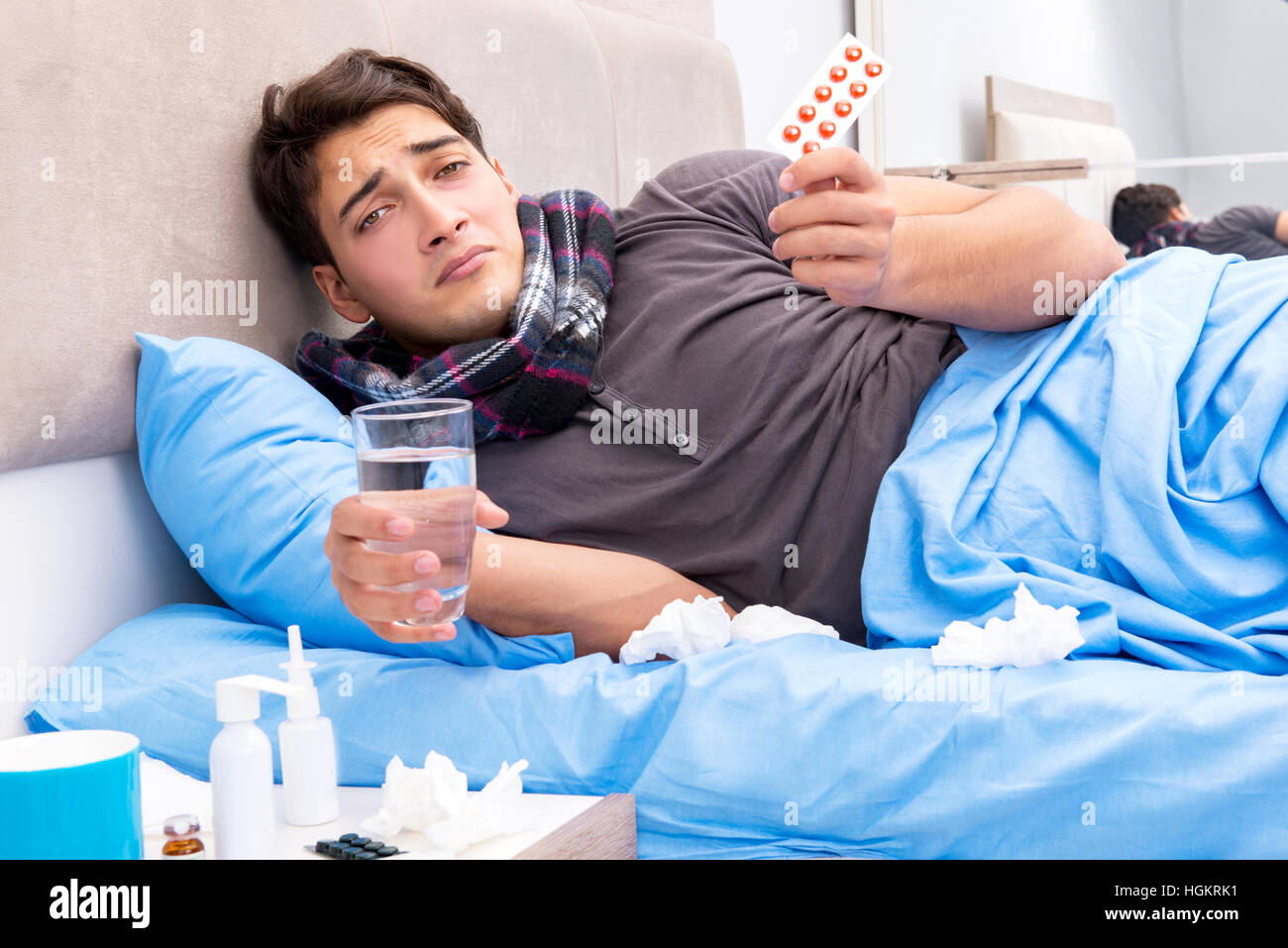 Sick man with flu lying in the bed Stock Photo - Alamy