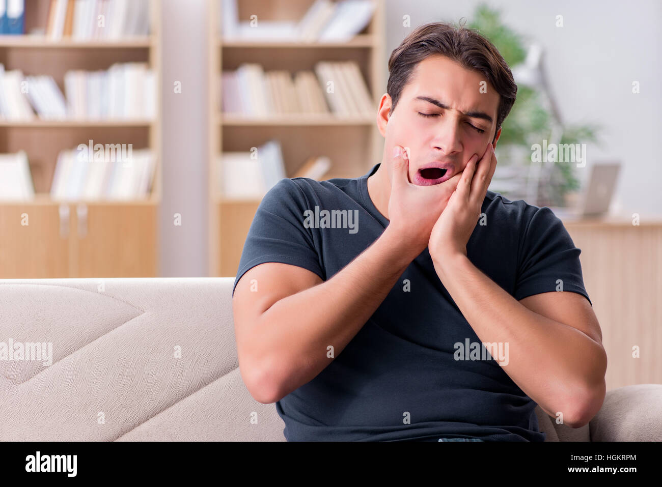 Young handsome man suffering from pain Stock Photo - Alamy
