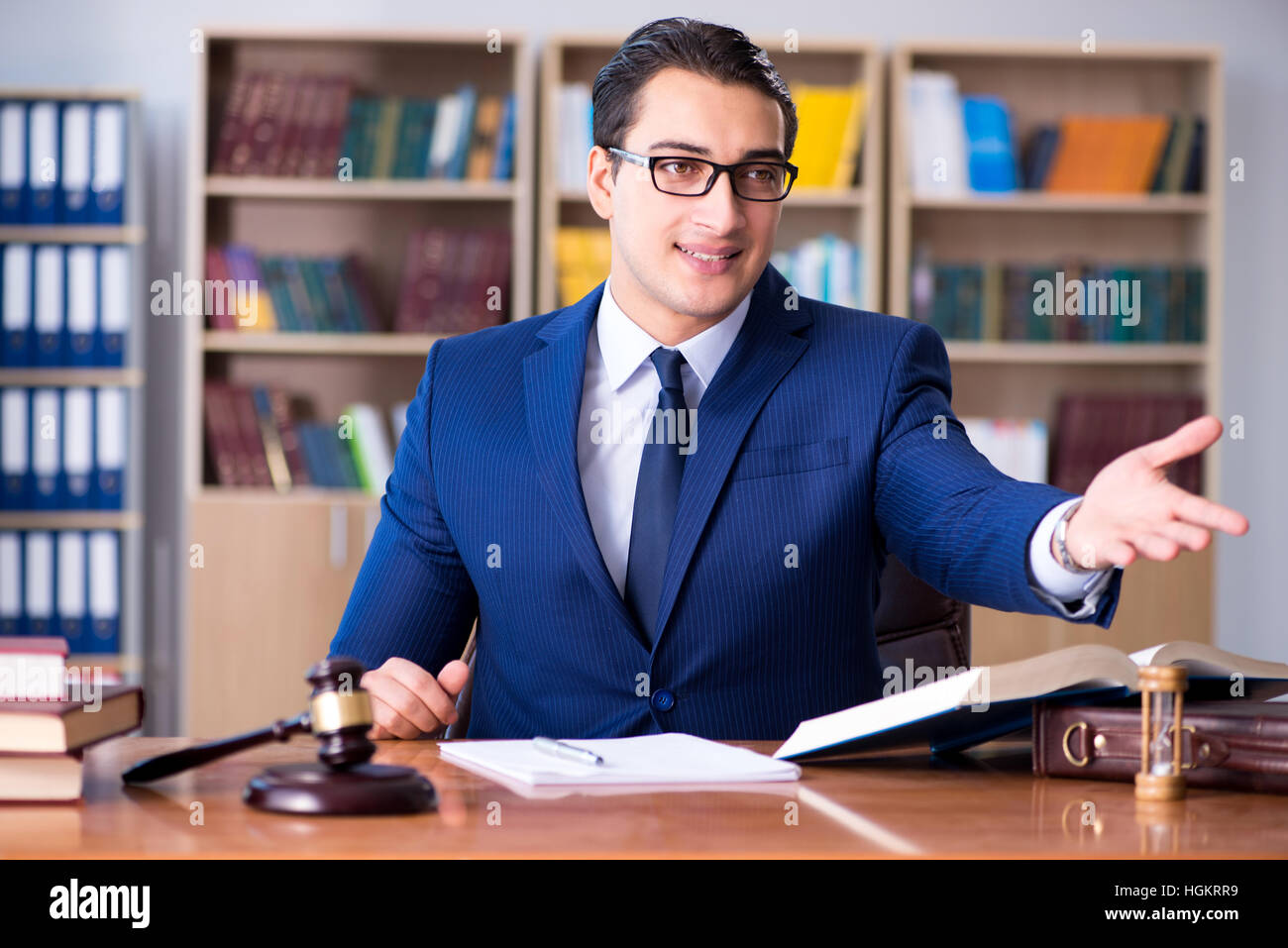 Handsome judge with gavel sitting in courtroom Stock Photo - Alamy