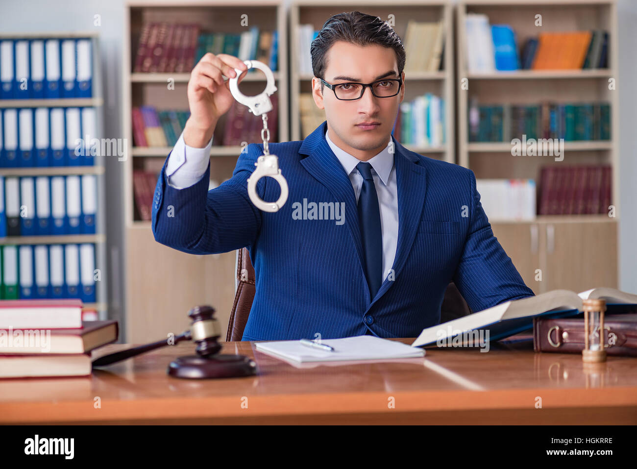 Handsome judge with gavel sitting in courtroom Stock Photo - Alamy