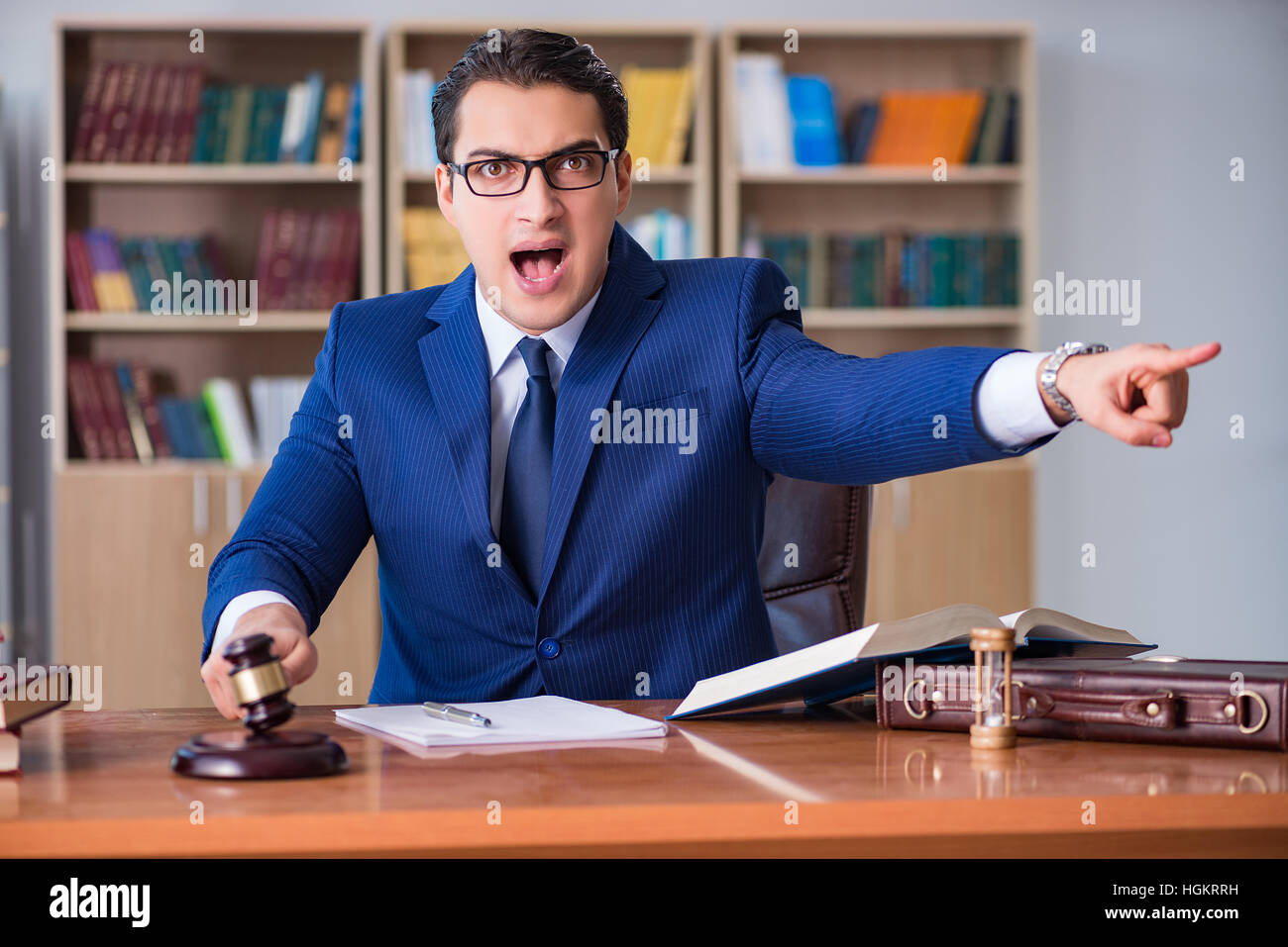 Handsome judge with gavel sitting in courtroom Stock Photo - Alamy