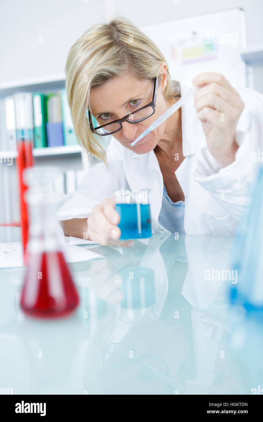 young female researcher carrying out experiments in a research lab ...
