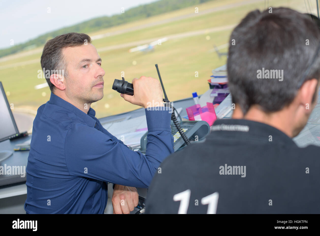 Man talking into receiver in air traffic control Stock Photo - Alamy