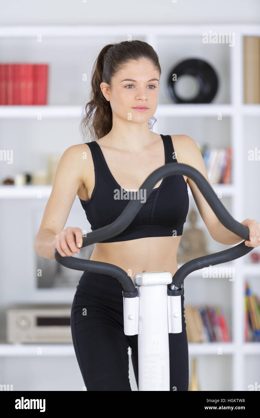 sporty girl training on exercise bike Stock Photo - Alamy