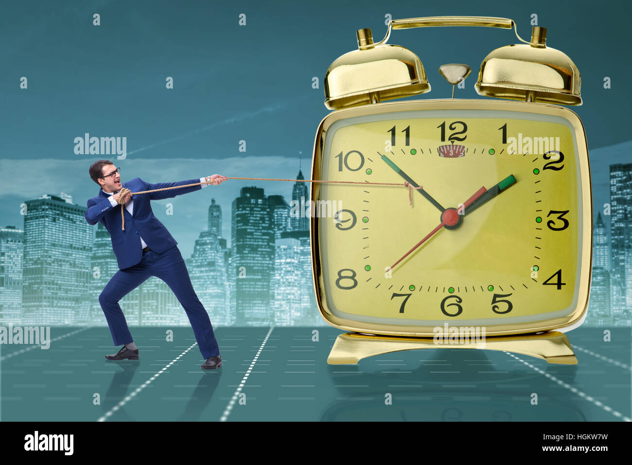 Businessman pulling clock in time management concept Stock Photo - Alamy