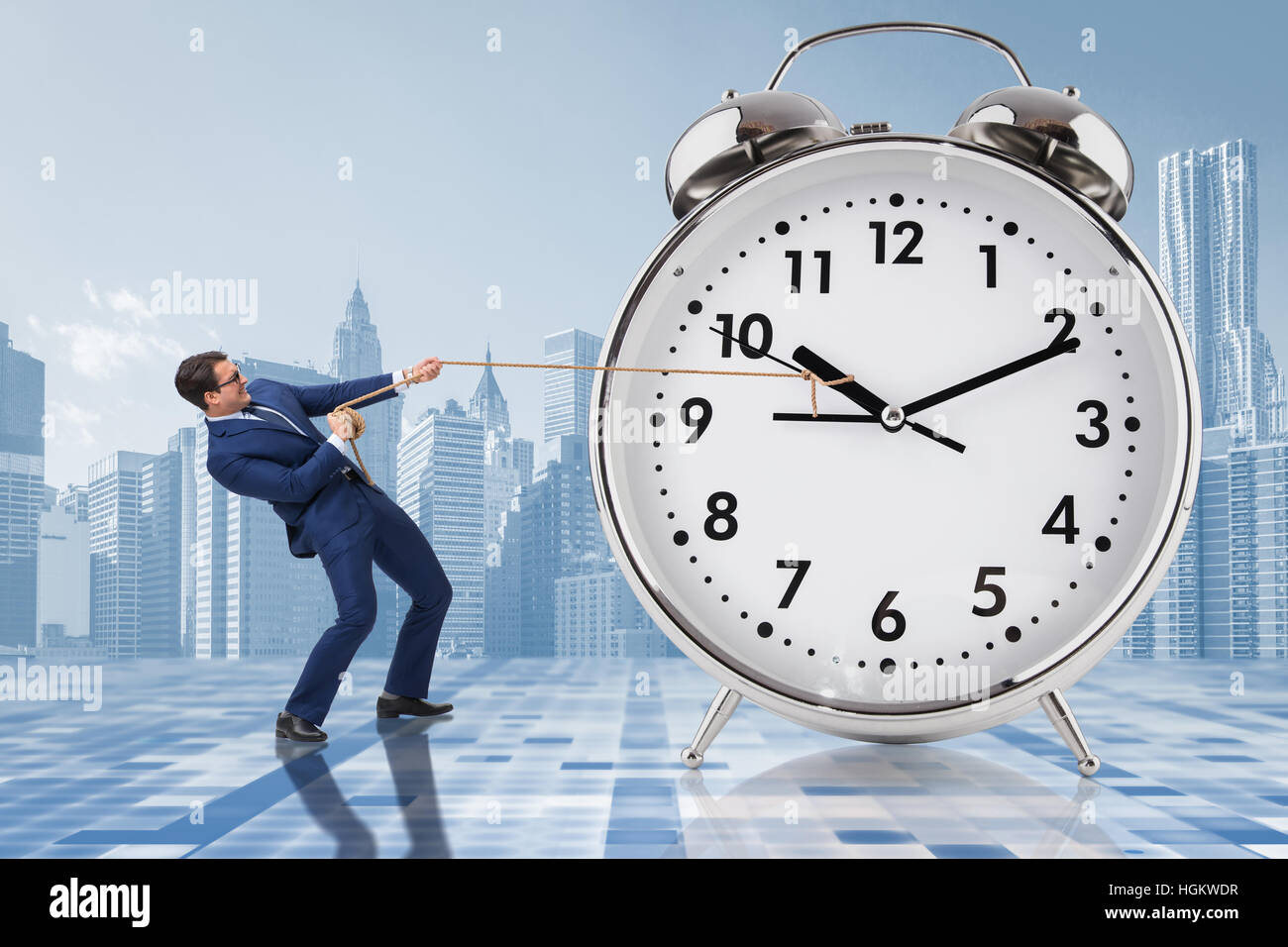 Businessman pulling clock in time management concept Stock Photo - Alamy