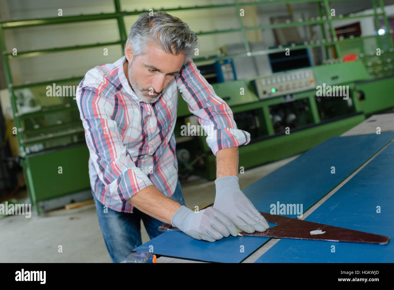 Man marking line on metal sheet Stock Photo - Alamy
