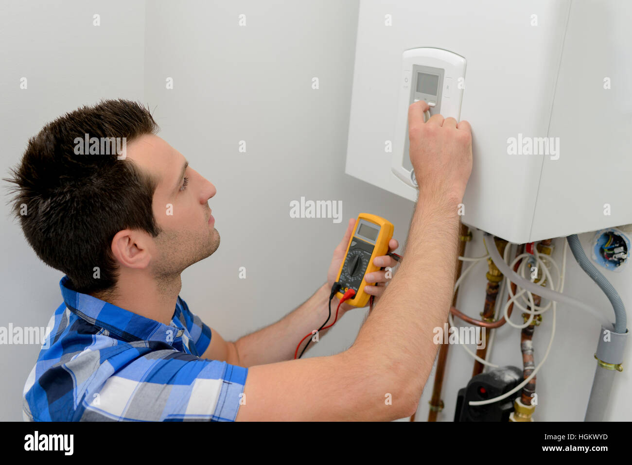 Man fixing the boiler Stock Photo - Alamy
