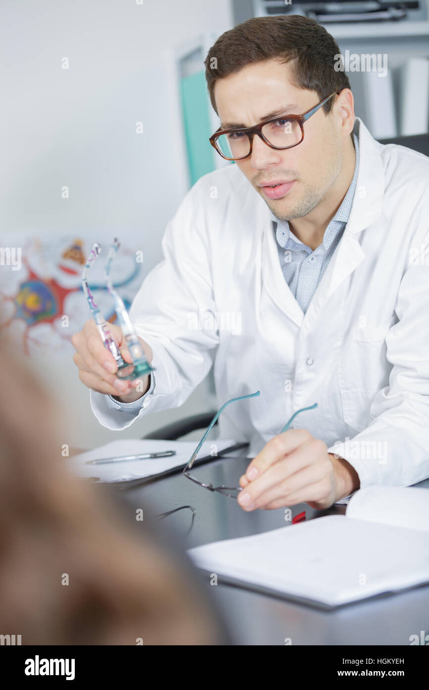 young skilled ophthalmologist talking to female patient Stock Photo - Alamy