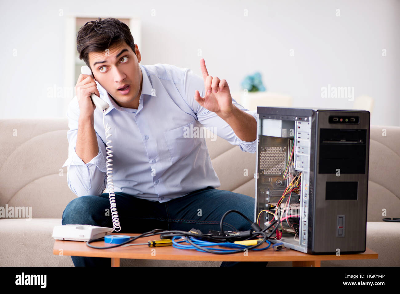 Angry customer trying to repair computer with phone support Stock Photo ...