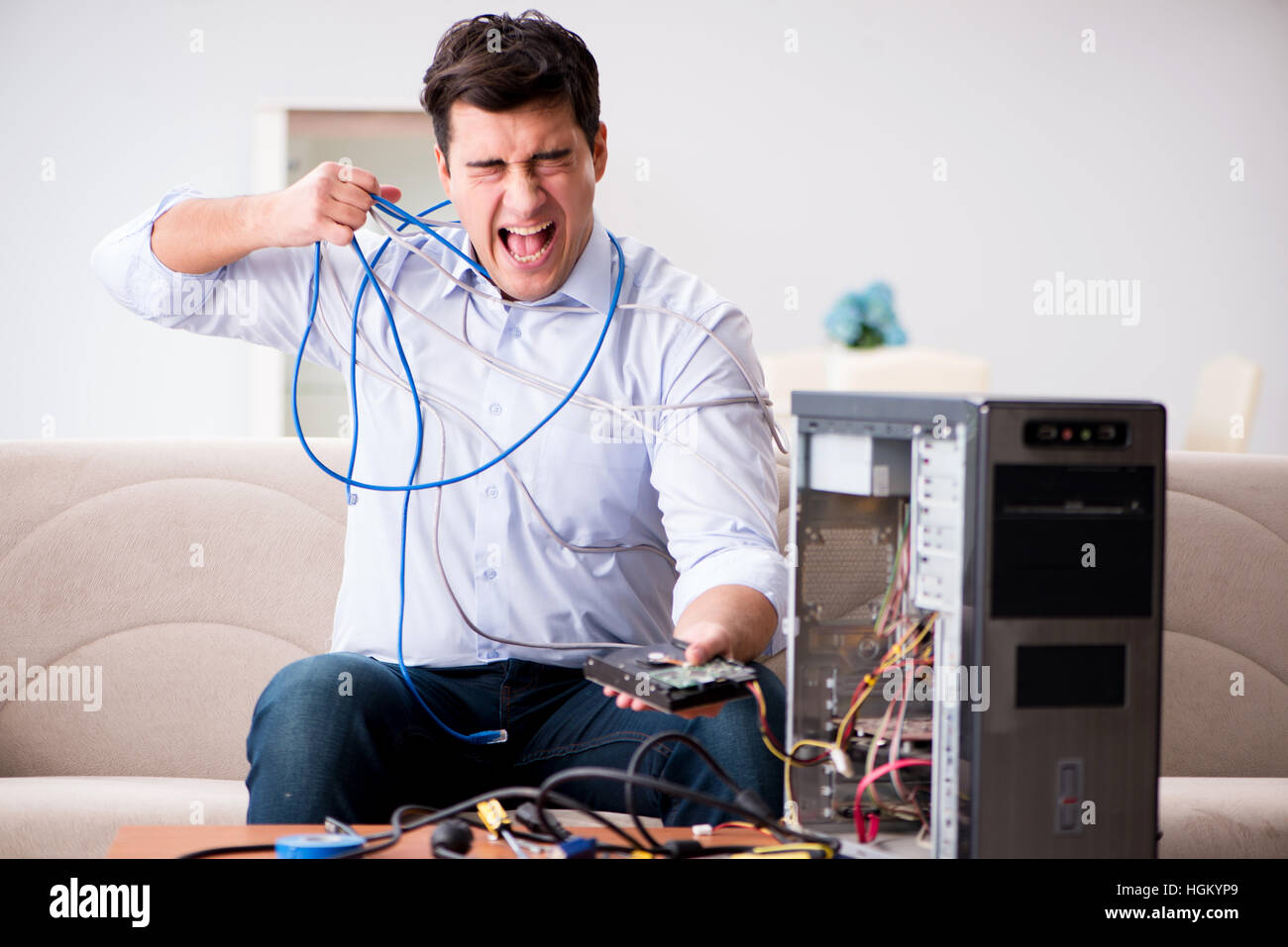 Frustrated man with broken pc computer Stock Photo - Alamy