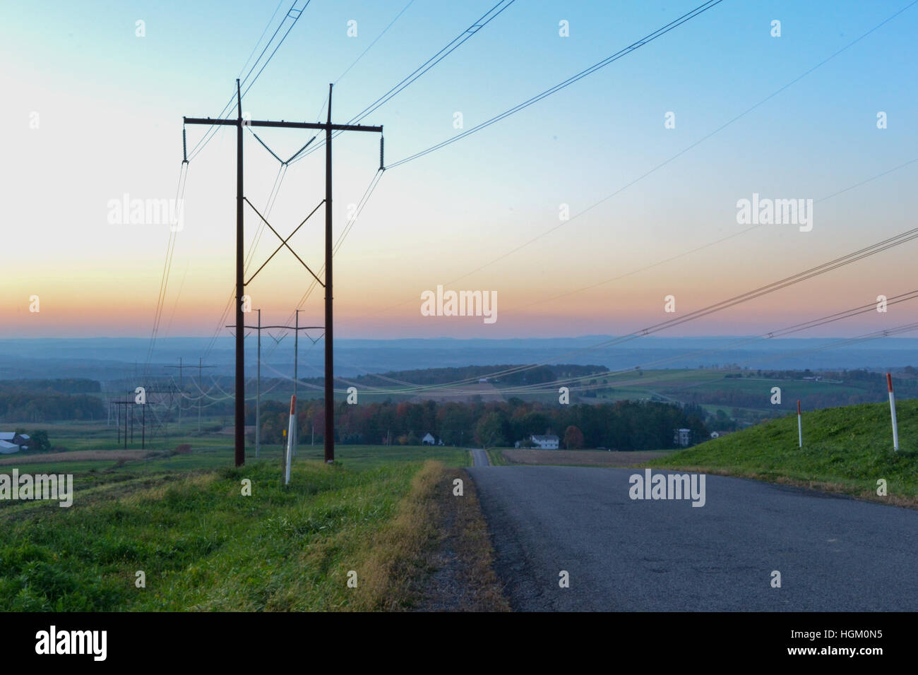 Powerlines next to a road in the country Stock Photo - Alamy