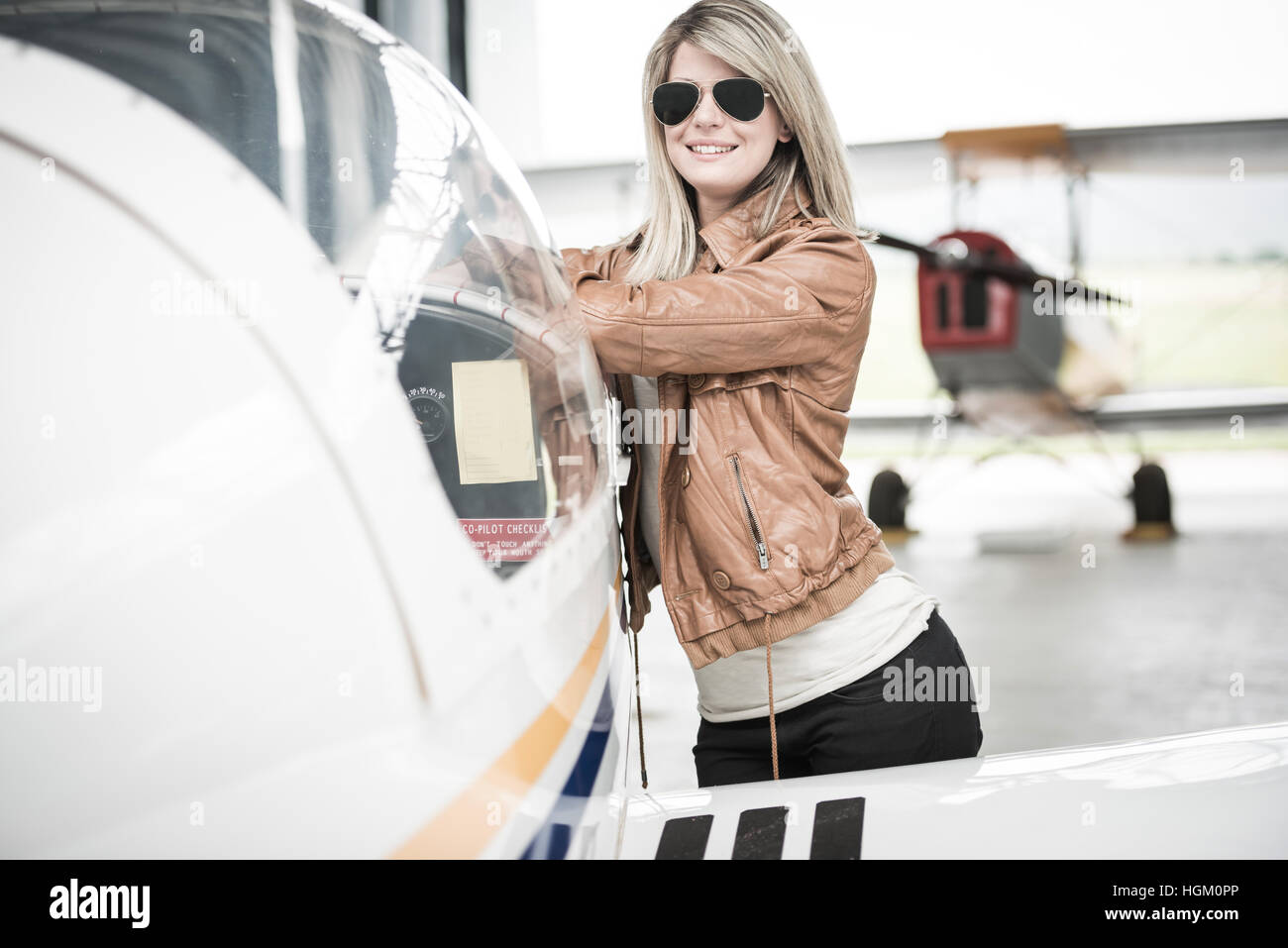 Female pilot standing next to her airplane Stock Photo - Alamy