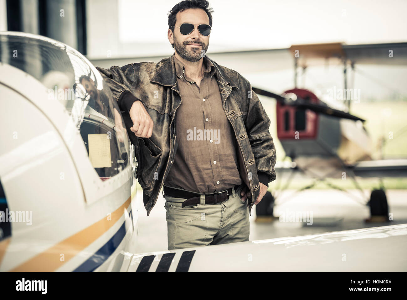 Pilot standing next to his airplane Stock Photo - Alamy
