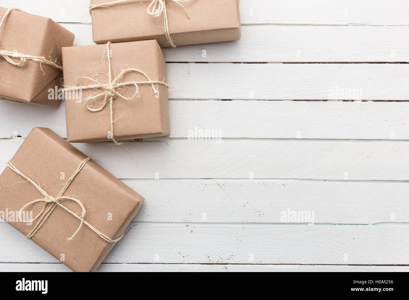 Christmas style rustic brown paper package tied up with strings. White ...