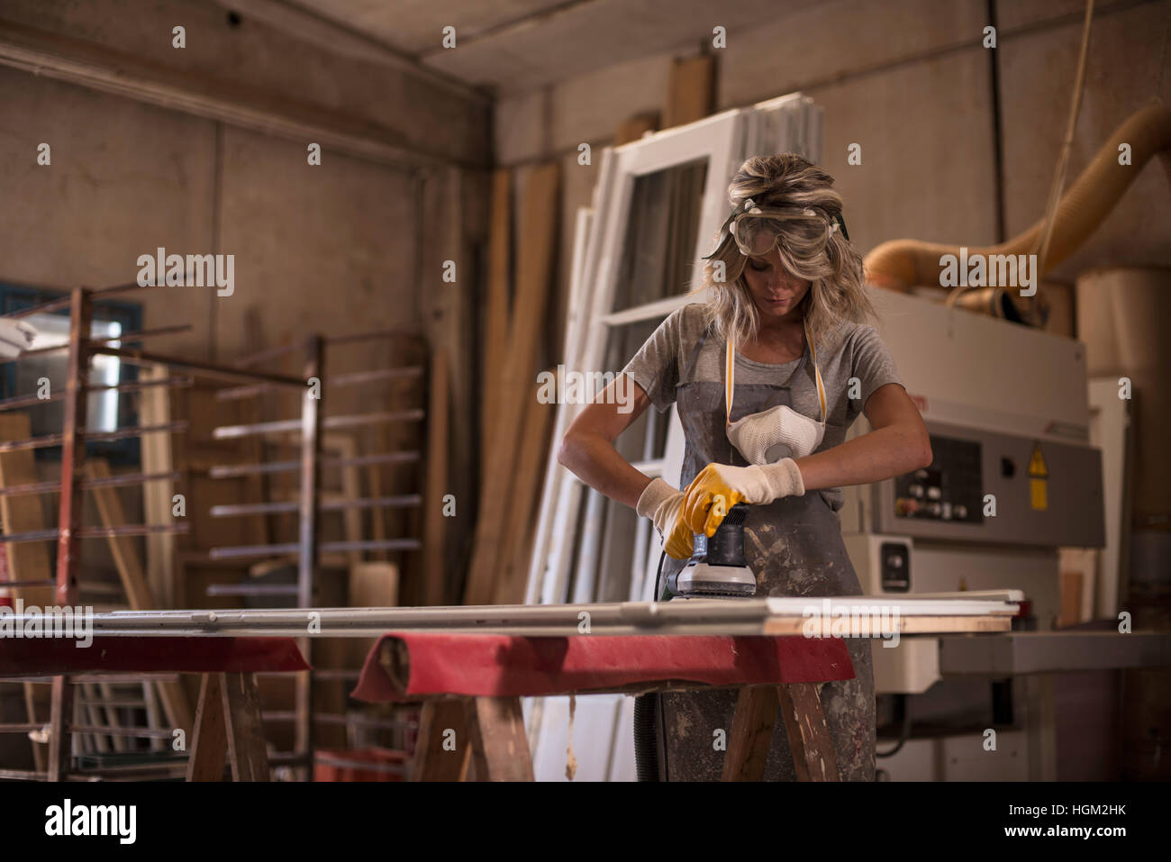 Female carpenter using power sander Stock Photo - Alamy
