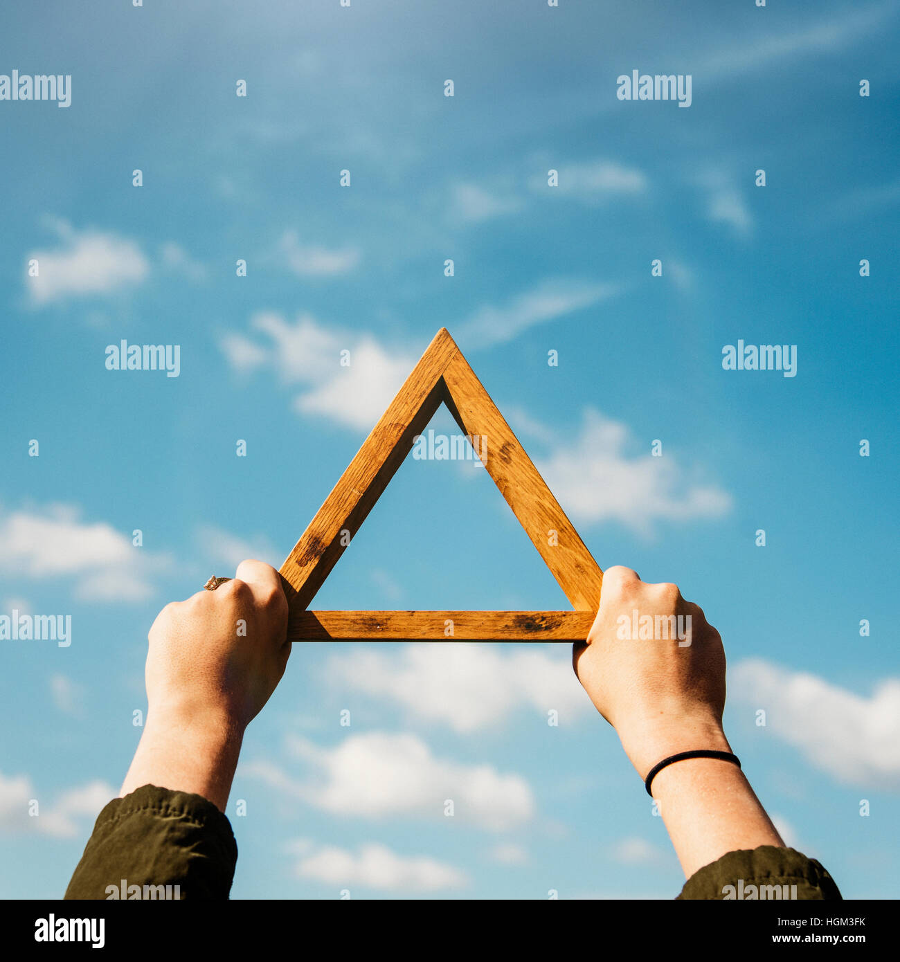 Hands Holding Triangle Symbol Cloudscape Concept Stock Photo - Alamy