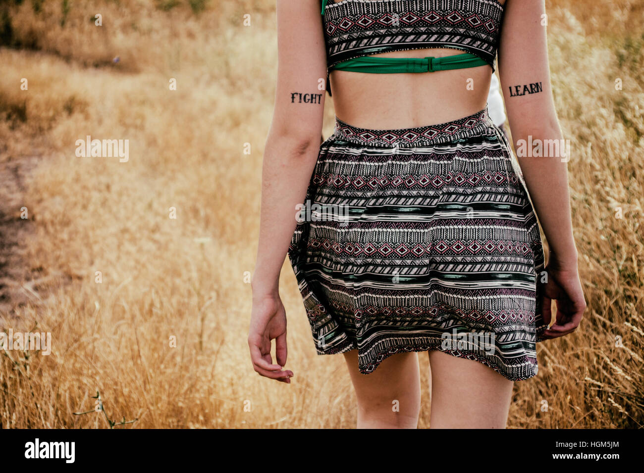 Young woman walking in summer back at camera Stock Photo - Alamy