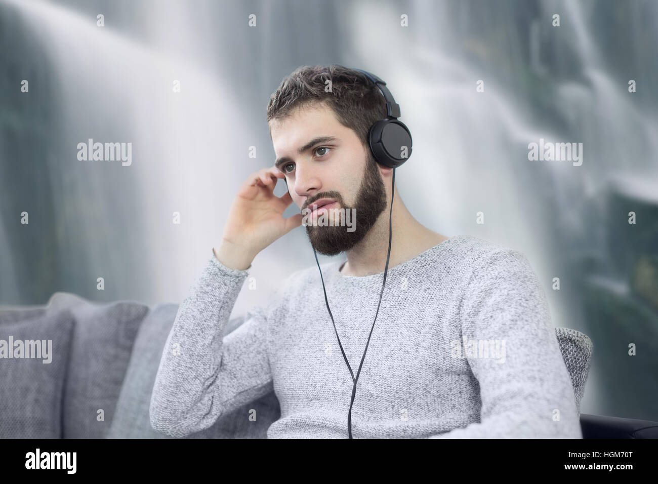 Man listening relaxation music by headset in nature at waterfall Stock ...