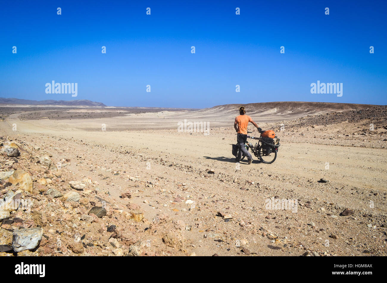 Adventurer in the deserted landscape of Dorob National Park, Damaraland ...