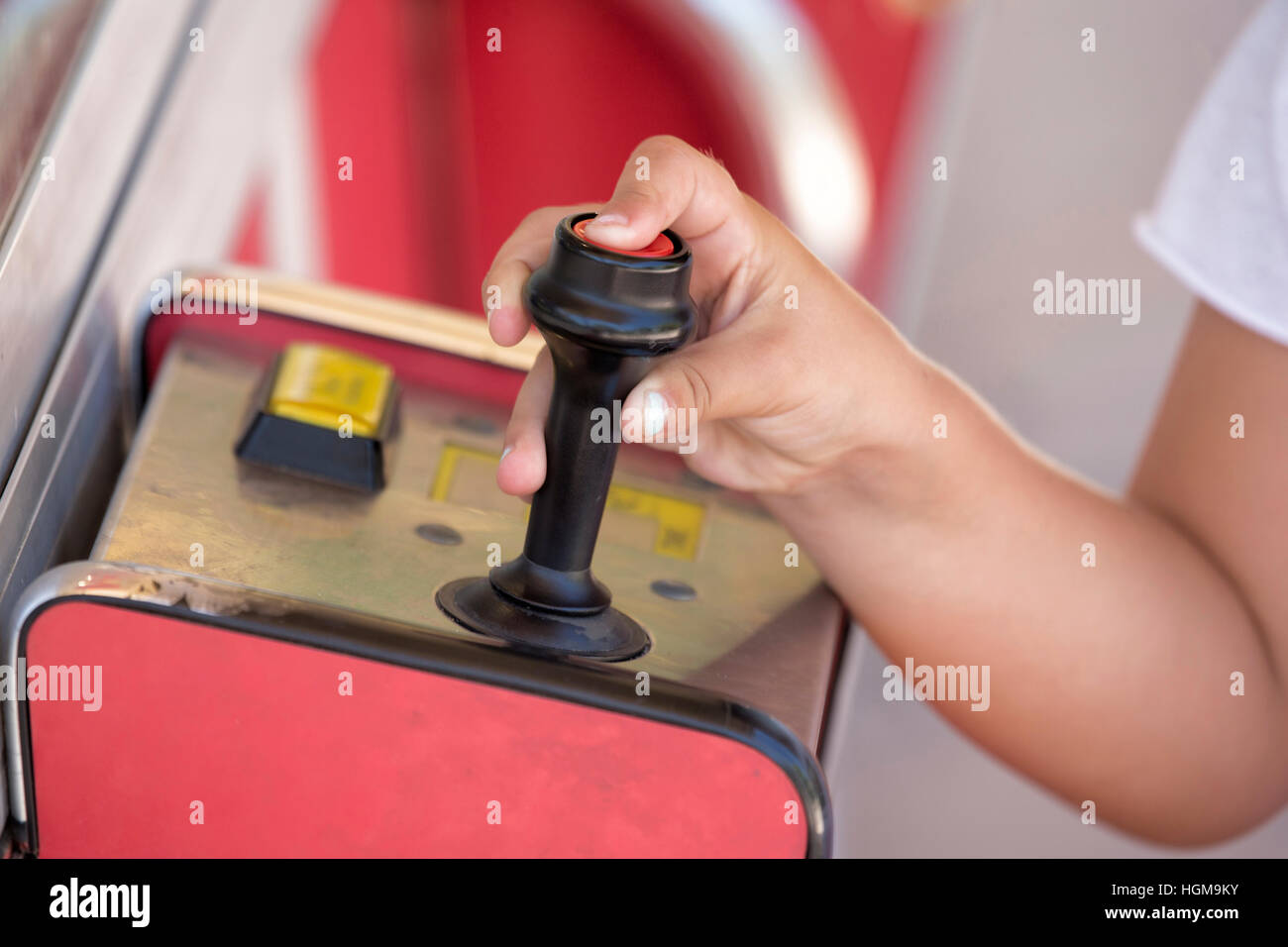 A kid pressing button on joystick. Horizontal outdoors shot Stock Photo ...