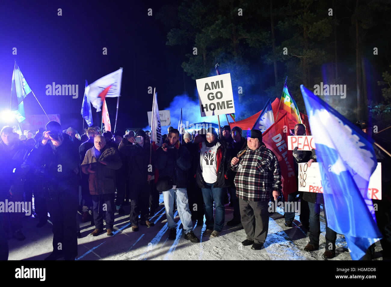 A demonstrator holds up a placard on which the words 'Ami [i.e ...