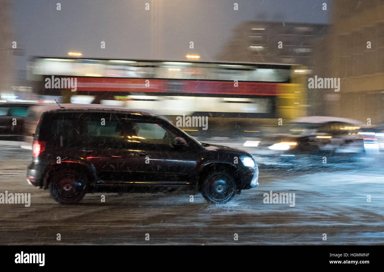 Berlin, Germany. 11th Jan, 2017. Cars drive through the brackish snow ...