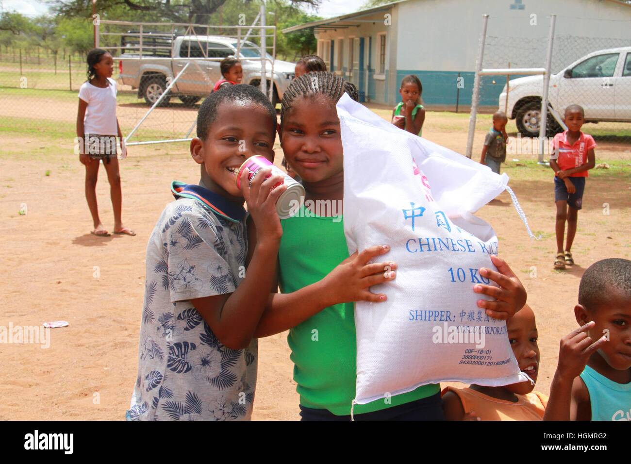 Windhoek, Namibia. 11th Jan, 2017. Children carry a bag of rice in ...