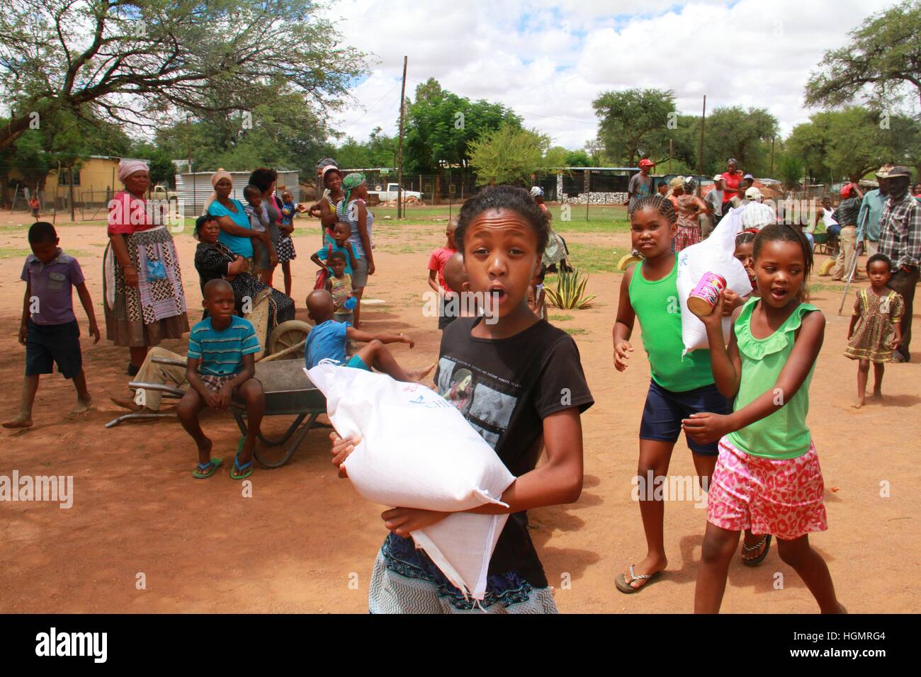 Windhoek, Namibia. 11th Jan, 2017. Children carry bags of rice in ...
