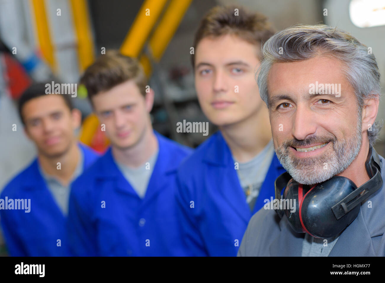 Tradesman with his three apprentices Stock Photo - Alamy
