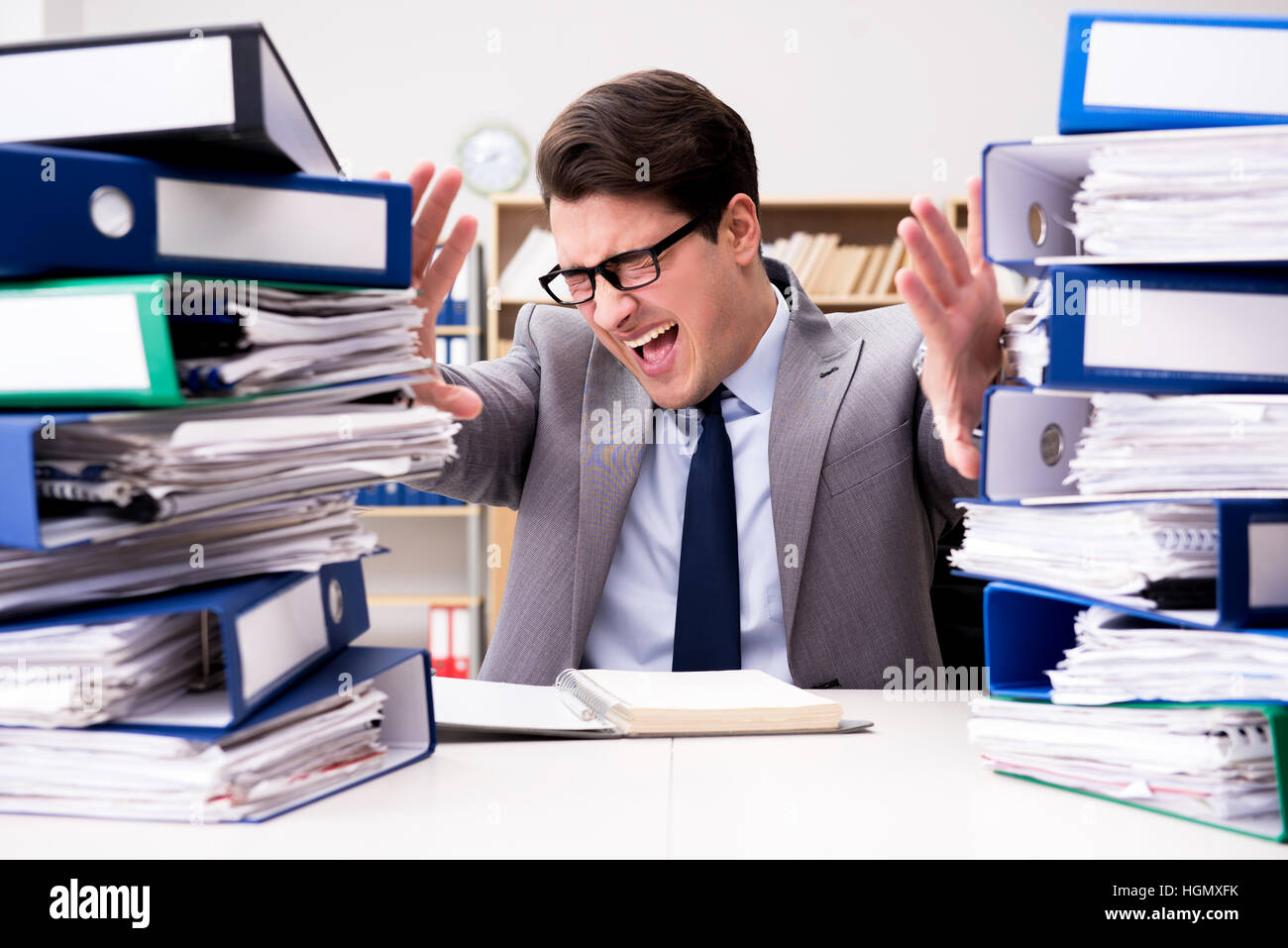 Busy businessman under stress due to excessive work Stock Photo - Alamy