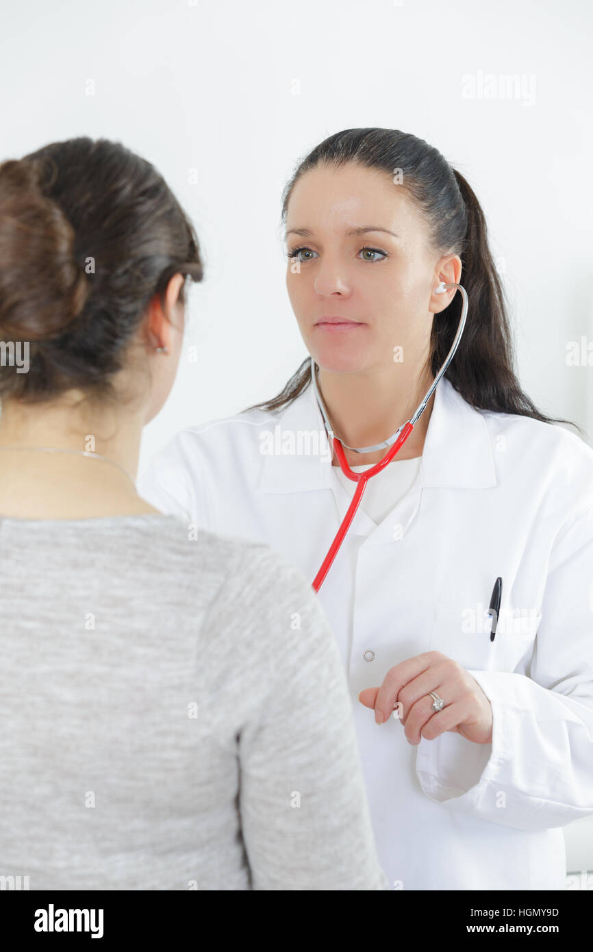 Auscultating patient with stethoscope hi-res stock photography and ...