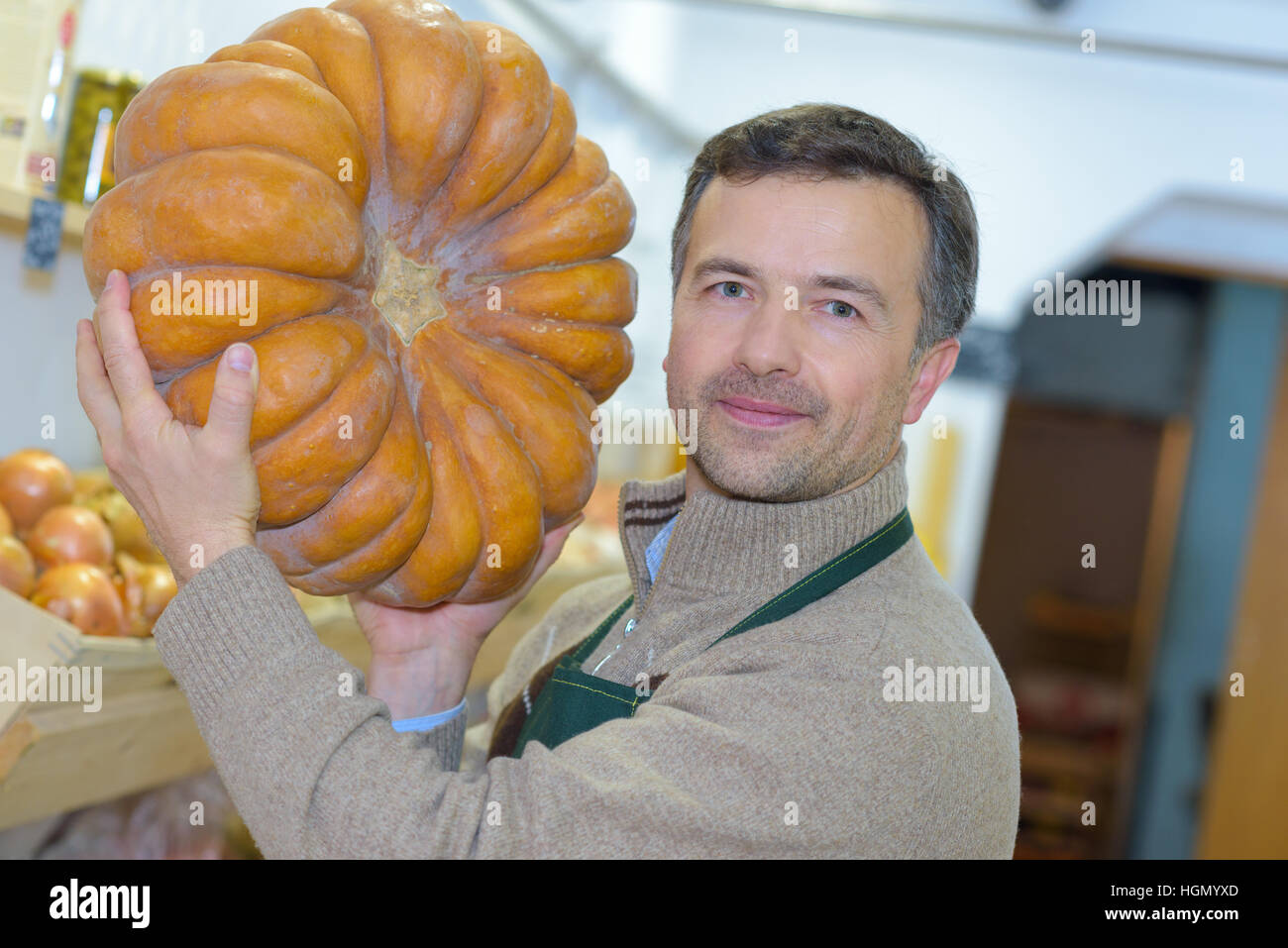Man holding large pumpkin Stock Photo - Alamy