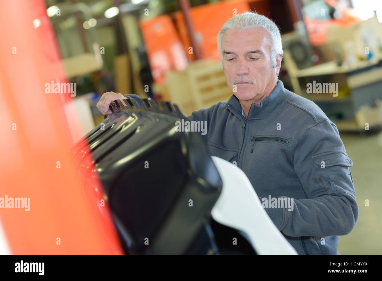 Worker putting object into container Stock Photo - Alamy