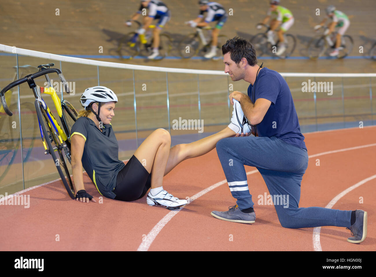 Instructor pushing against cyclist's foot Stock Photo - Alamy