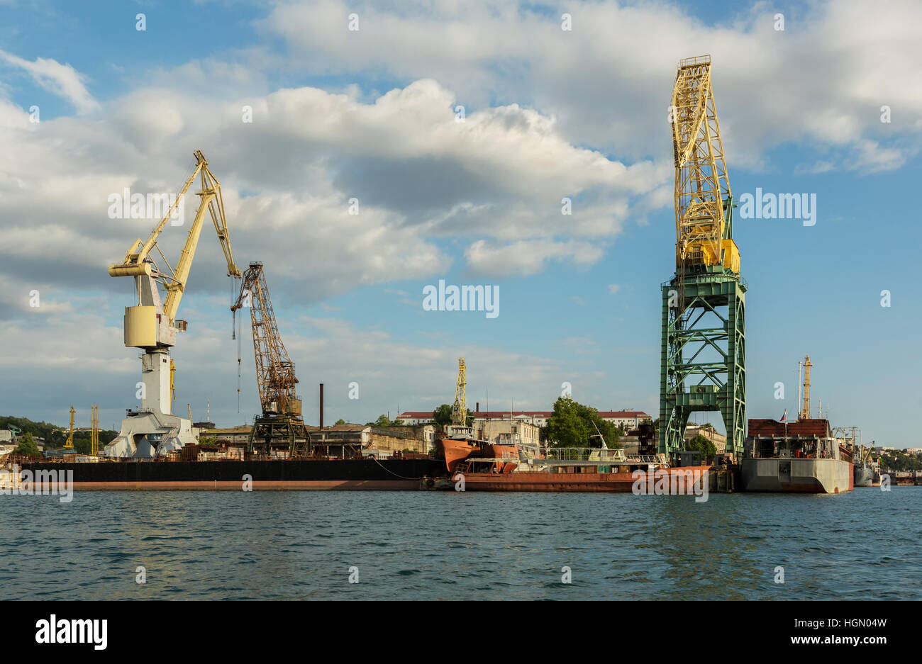 Lifting cargo cranes at the shipyard in Bay of Black Sea Stock Photo ...