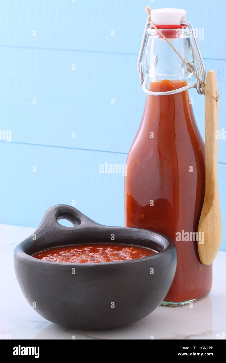 Artisan mexican red hot sauce on retro vintage carrara marble in ...